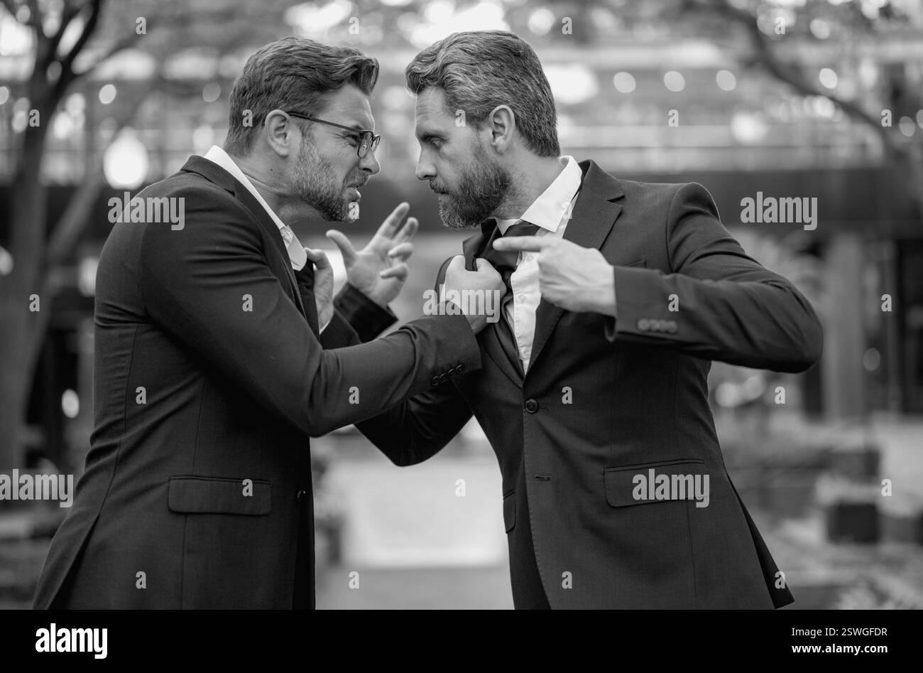 Two fighting businessmen punching. Businessmen fighting outdoor ...