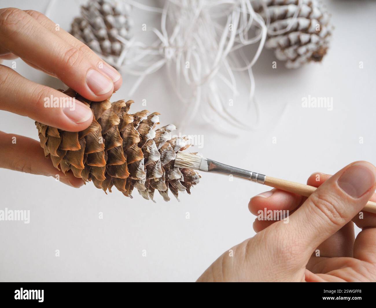 Making handmade Christmas decorations. pine cone Stock Photo - Alamy