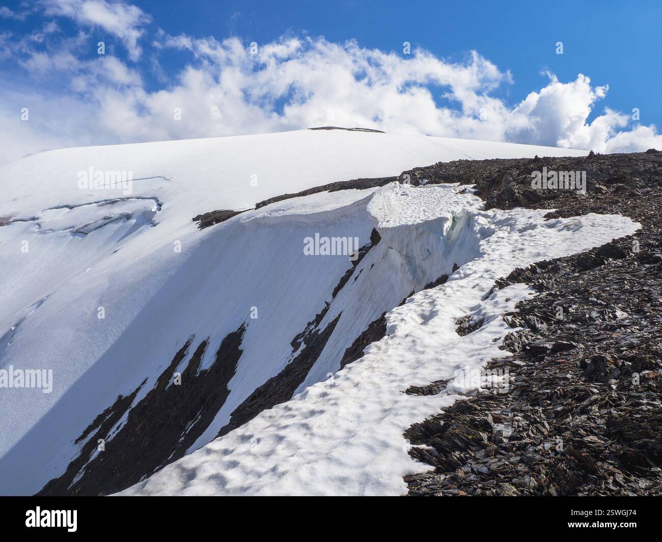 Dangerous snow ledge on the top of the mountain. Ledges from the snowy ...