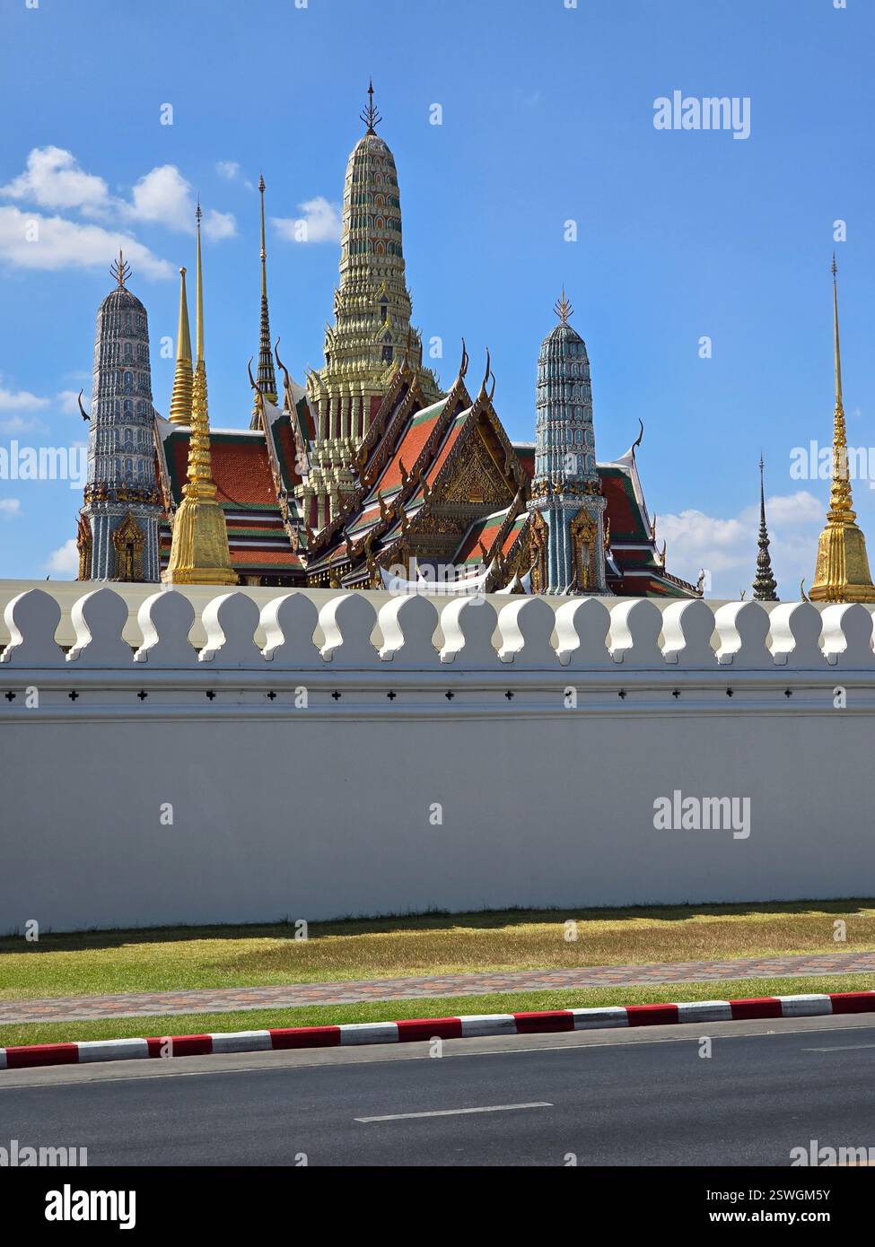 Wat Phra Kaew temple, Grand Royal Palace rise high into the azure sky ...