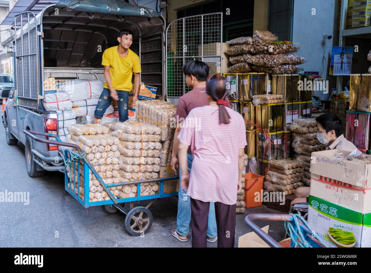 Busy market day in Bangkok as vendors unload fresh produce and supplies ...