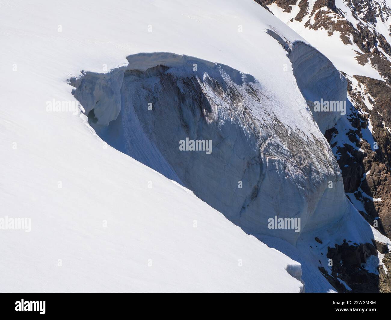 Dangerous snow ledge on the top of the mountain. Ledges from the snowy ...