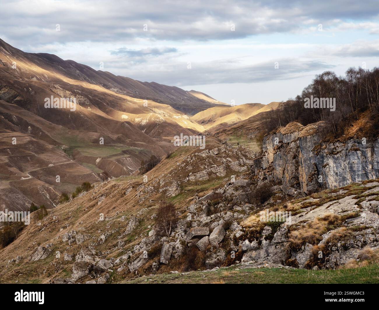 Dramatic alpine scenery with high mountain valley in sunlight and in ...