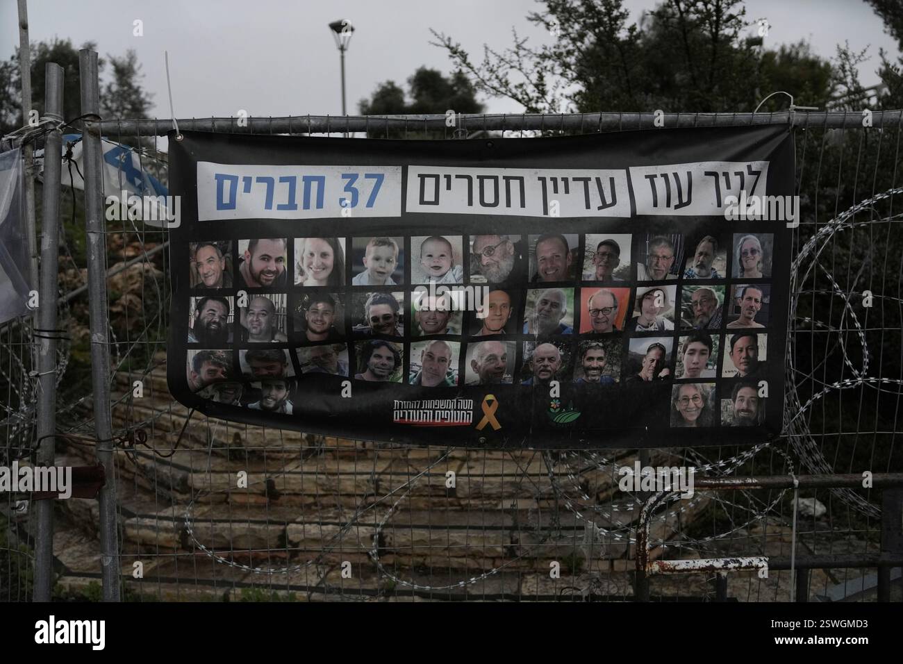 A poster shows portraits of Bibas family, top row from second left ...