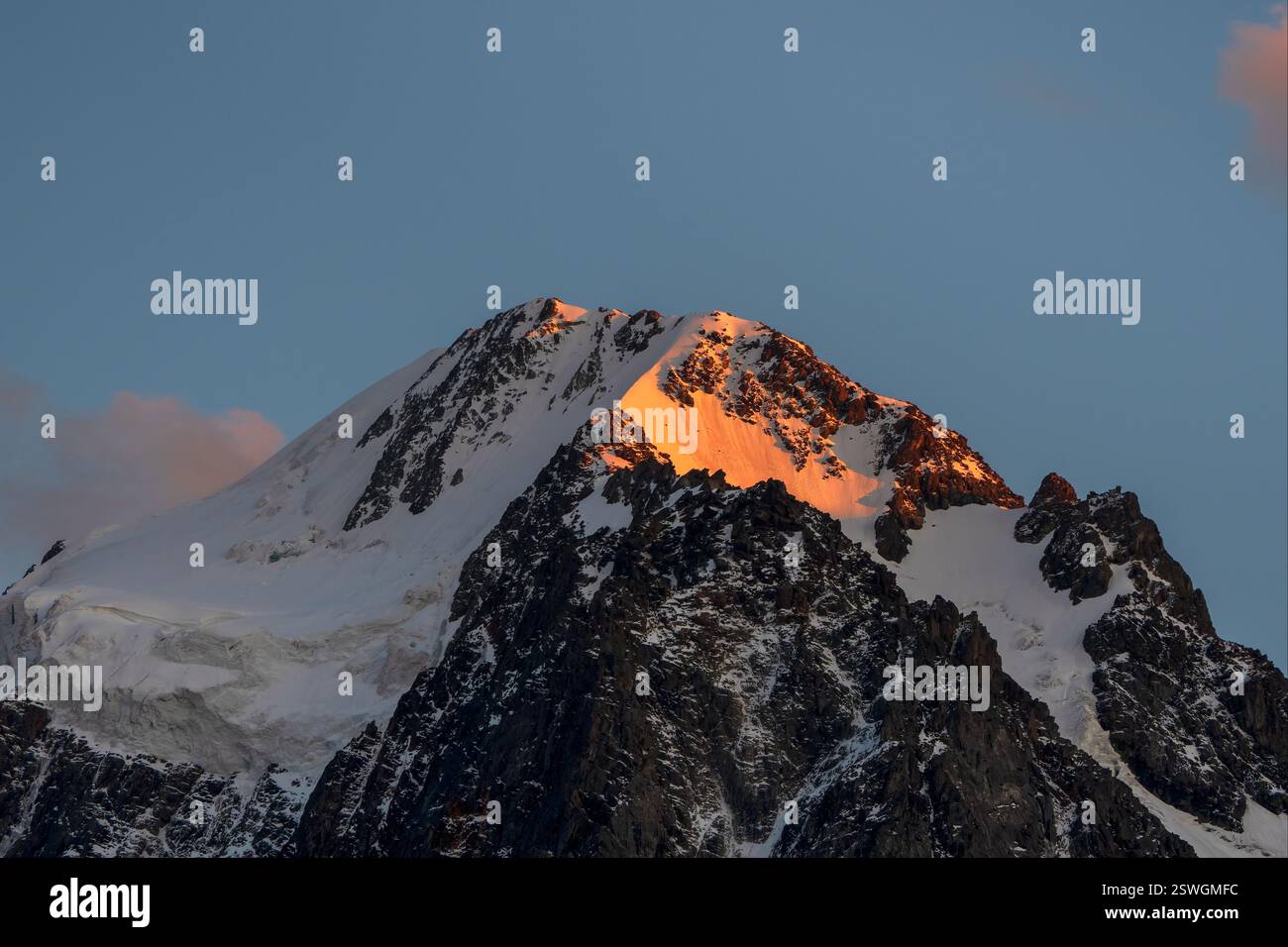 Beautiful red shiny snowy top. Atmospheric alpine landscape to snowy ...
