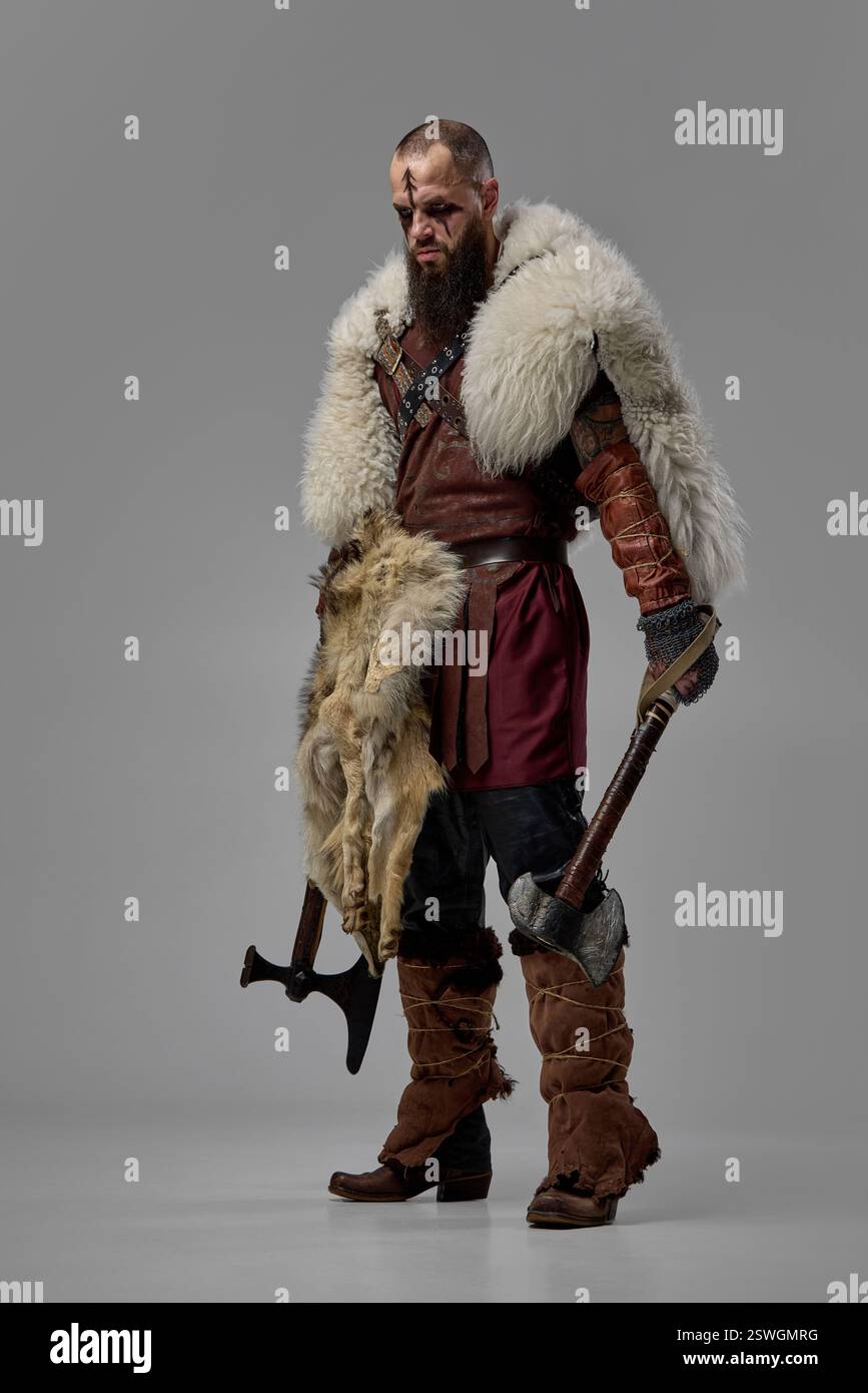 Full-length portrait of fierce man, medieval warrior, Viking in full ...