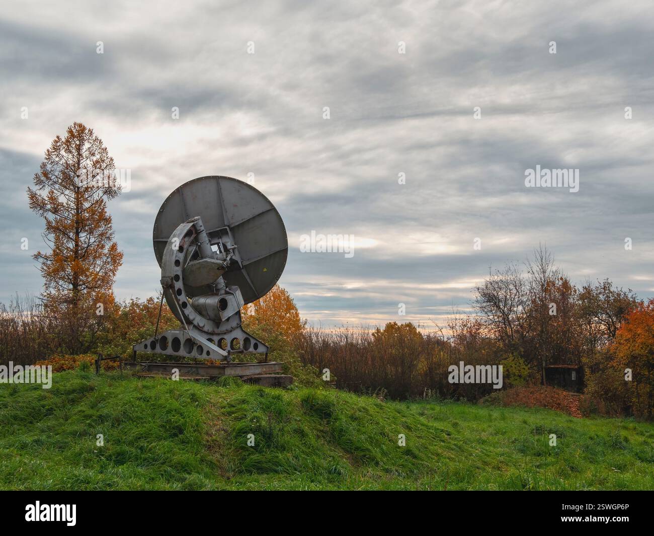 Vintage telescope a large satellite dish on a background of observation ...