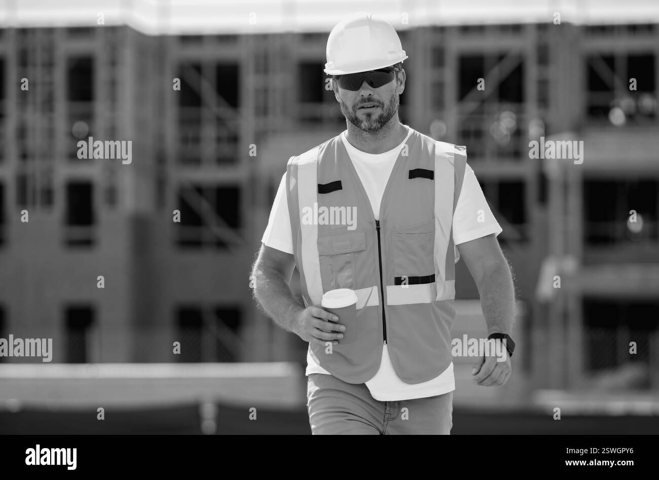 Construction site worker in helmet working outdoor. Builder in helmet ...