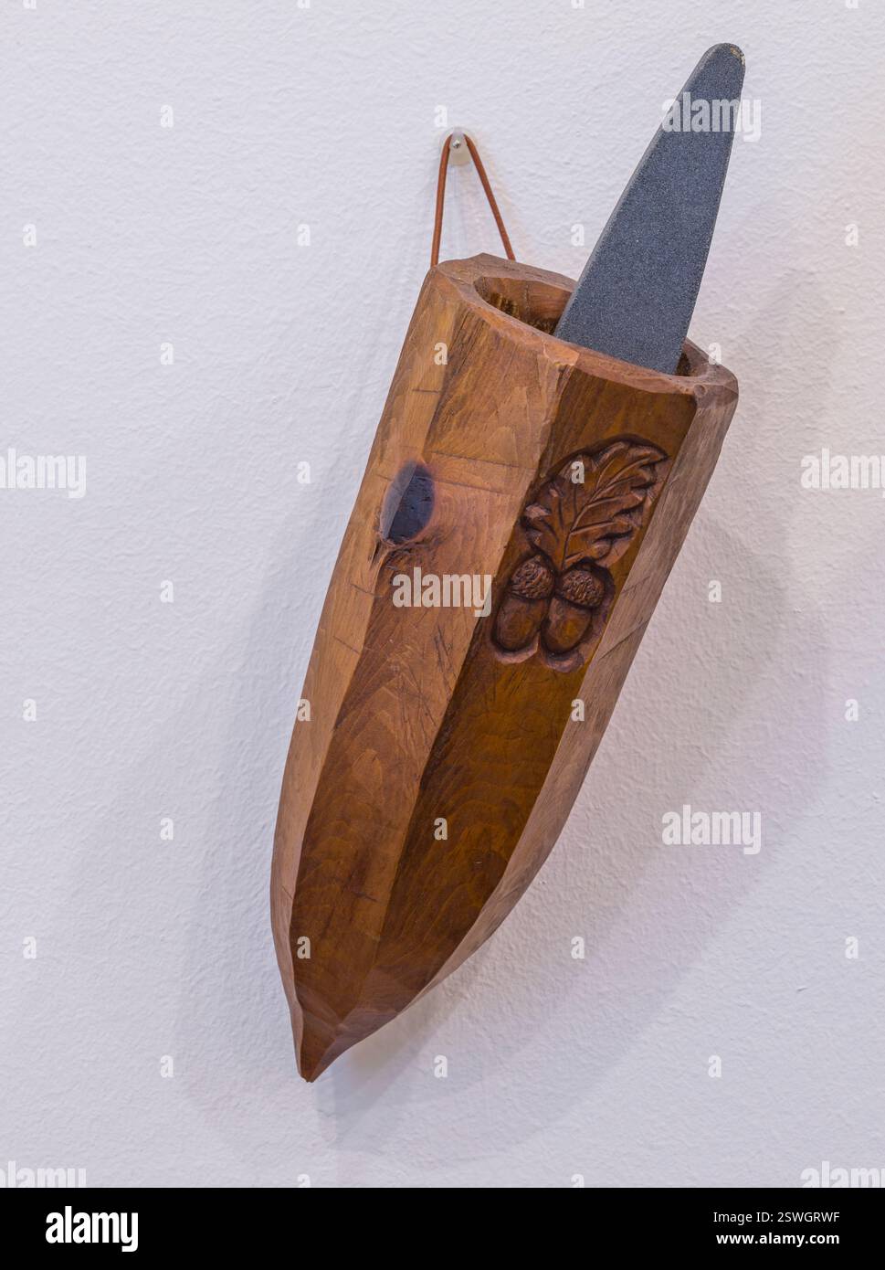 Decorated wooden sheath containing a sharping stone, used by the ...