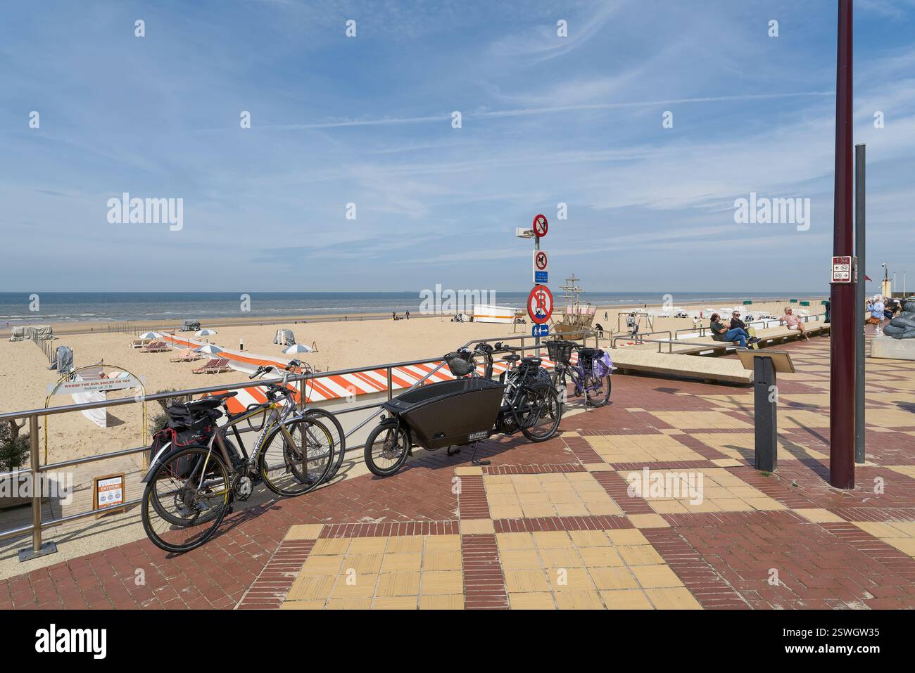 Bicycles on the promenade on the beach at De Haan on the Belgian North ...