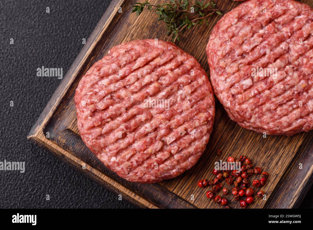 Fresh raw ground beef burger patty with salt and spices Stock Photo - Alamy