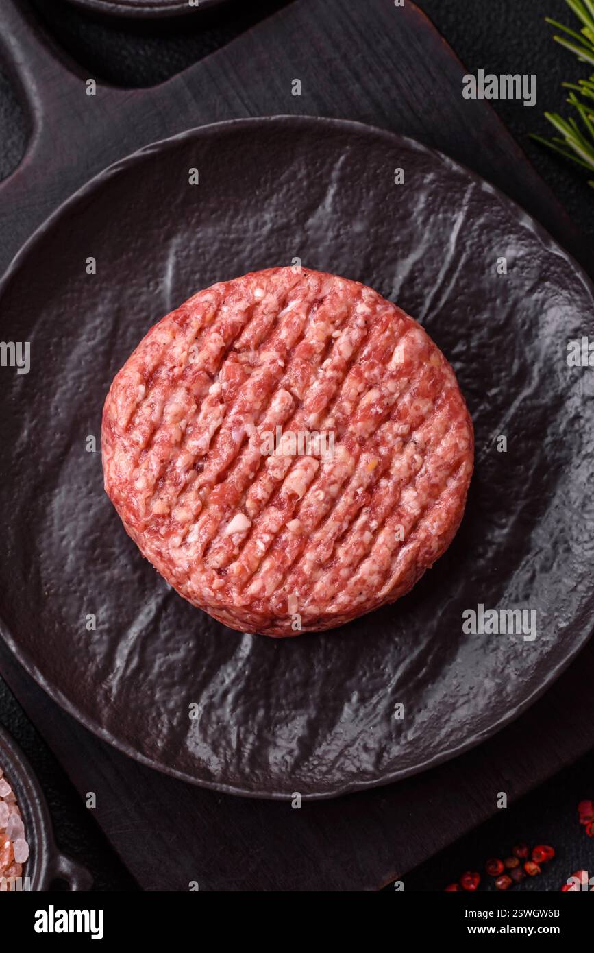 Fresh raw ground beef burger patty with salt and spices Stock Photo - Alamy