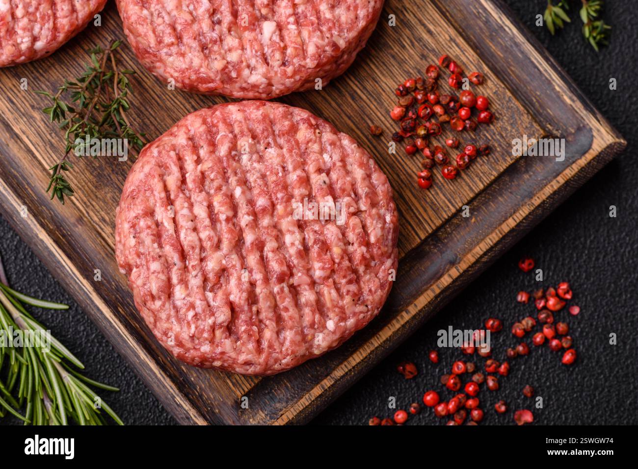Fresh raw ground beef burger patty with salt and spices Stock Photo - Alamy