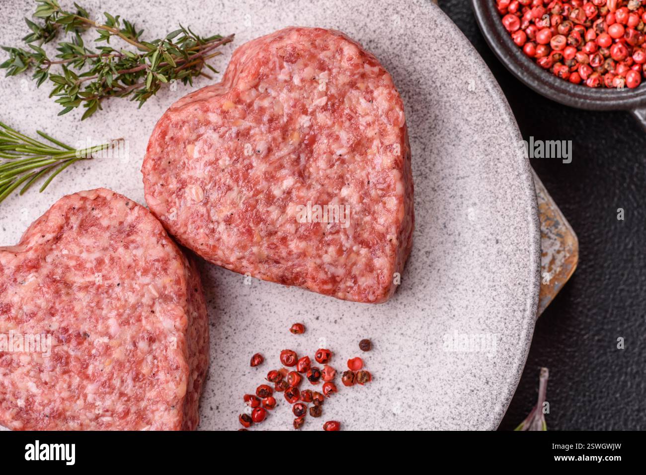 Raw beef or pork burger patty in the shape of a heart Stock Photo - Alamy