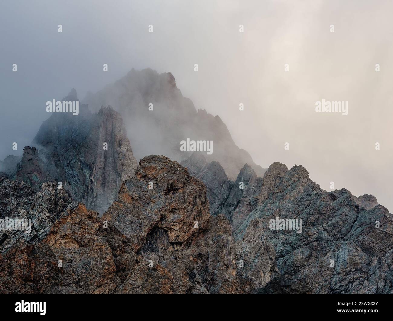 Atmospheric ghostly landscape with fuzzy silhouettes of sharp rocks in ...