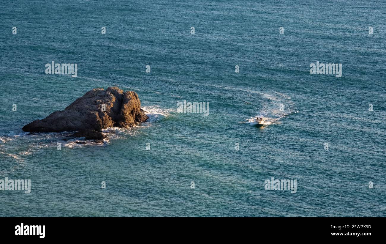 Boat trip. Black sea coast. Little boat in the sea near rock cliff ...
