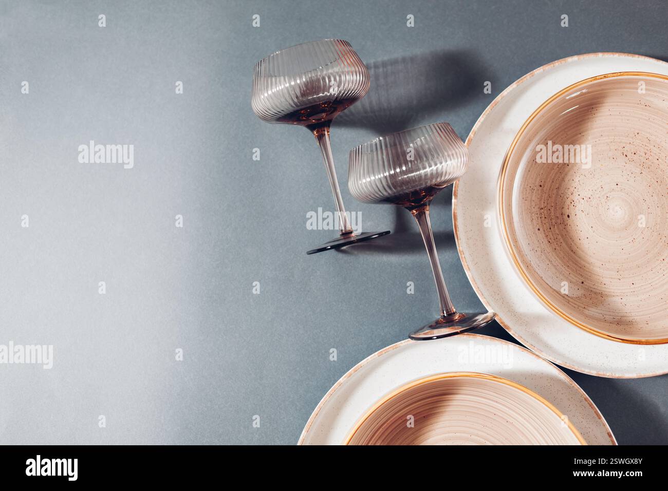 Set of modern glazed ceramic dishware on grey background. Soup bowls ...