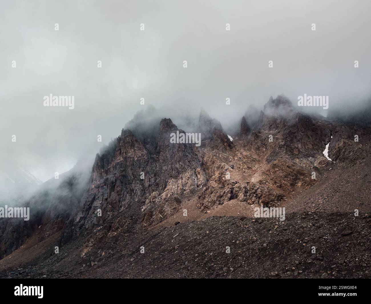 Mountains in a dense fog. Mystical landscape with beautiful sharp rocks ...
