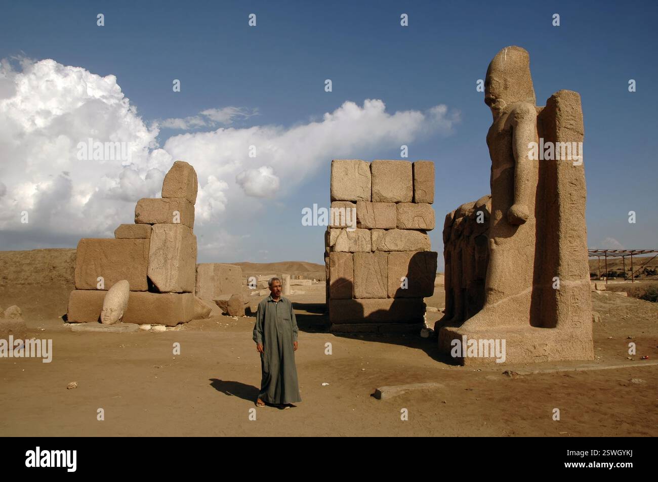 An Egyptian man stands by monumental gateway of Shoshenq III at the ...
