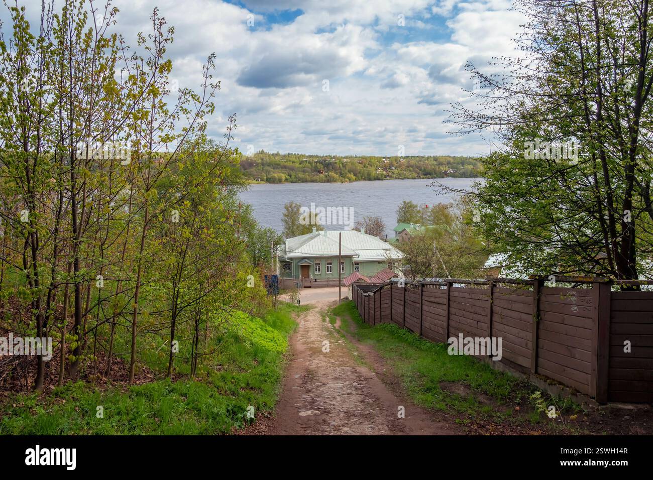 Beautiful rural wooden house on the slope by the river at the end of ...