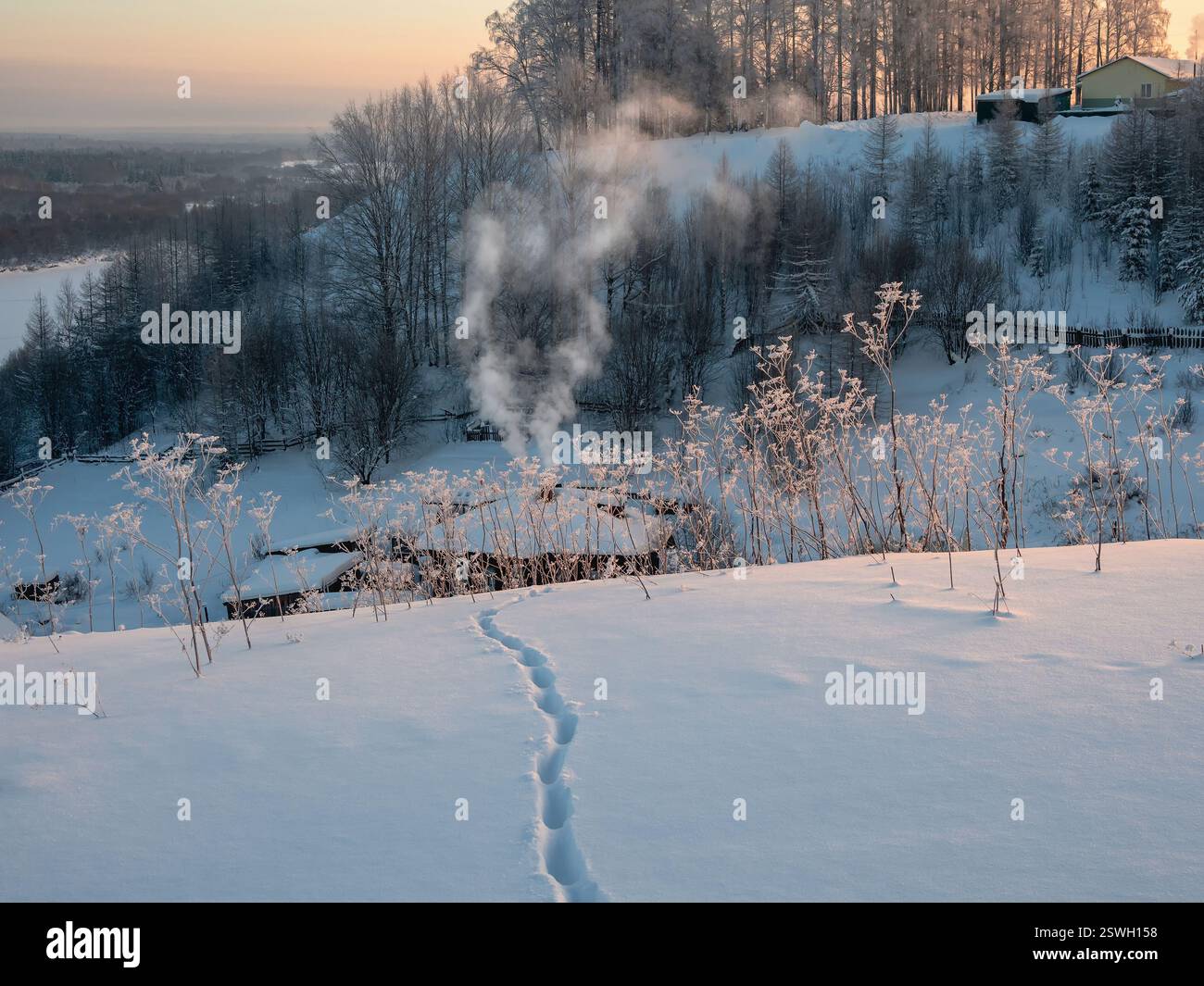 Foot path through deep snow to a hut in a snow-covered ravine Stock ...
