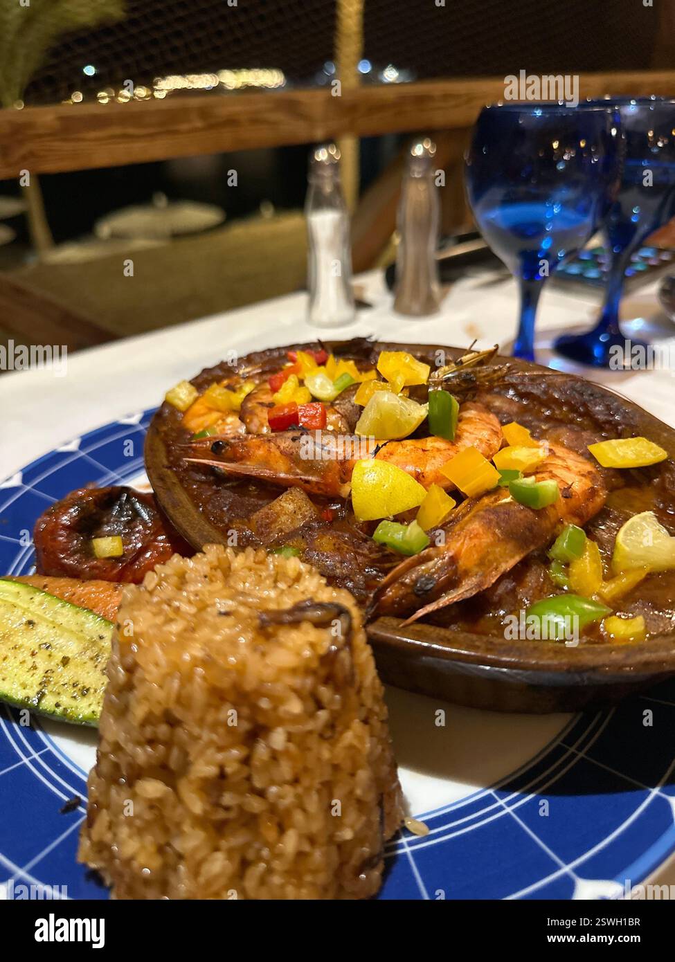 Seafood tagine with shrimps and calamari cooked in tomato sauce and ...