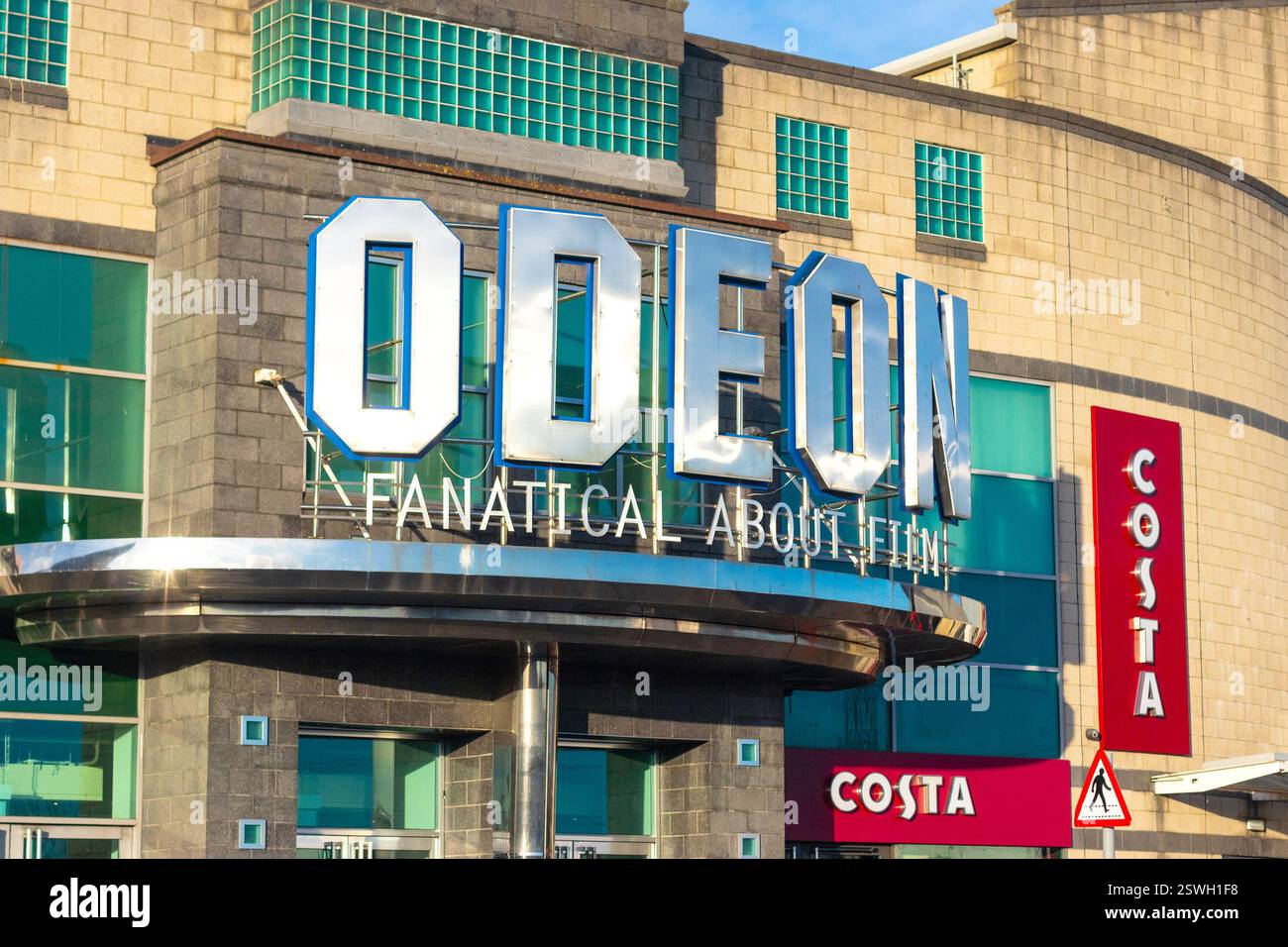 Exterior of Odeon cinema with distinctive signage & tower Costa coffee ...