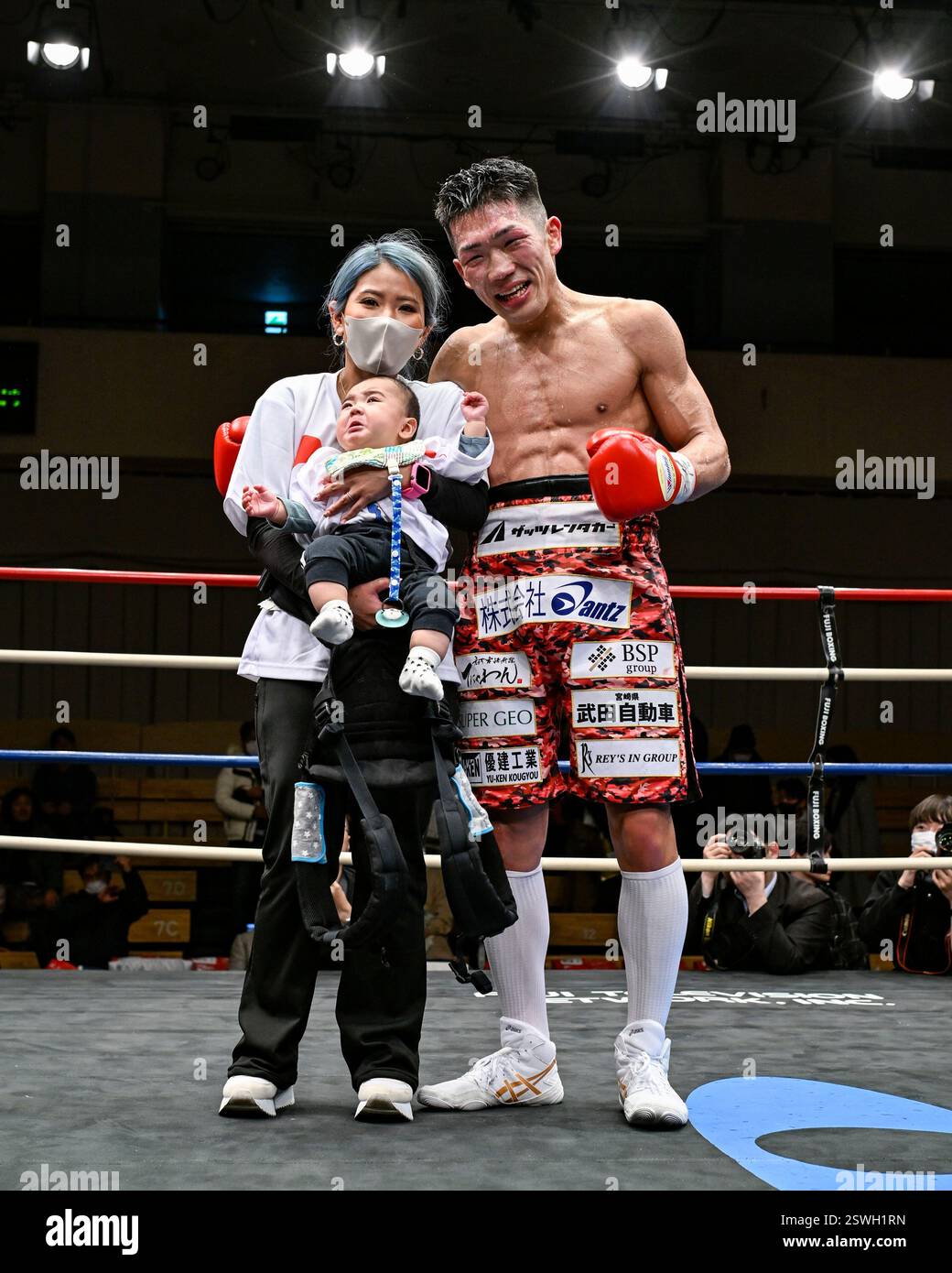 Champion Daishi Nagata, right, poses with his wife and son after winning his OPBF and WBO Asia ...