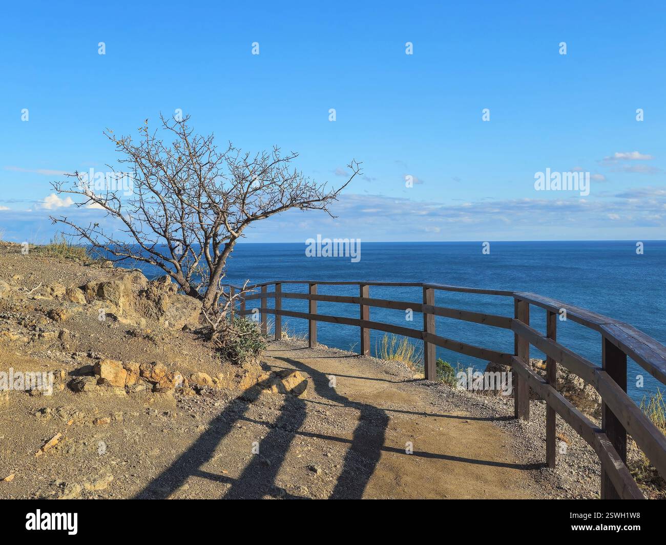Wooden fence on the edge of the cliff. Fine seaside walkway and Black ...