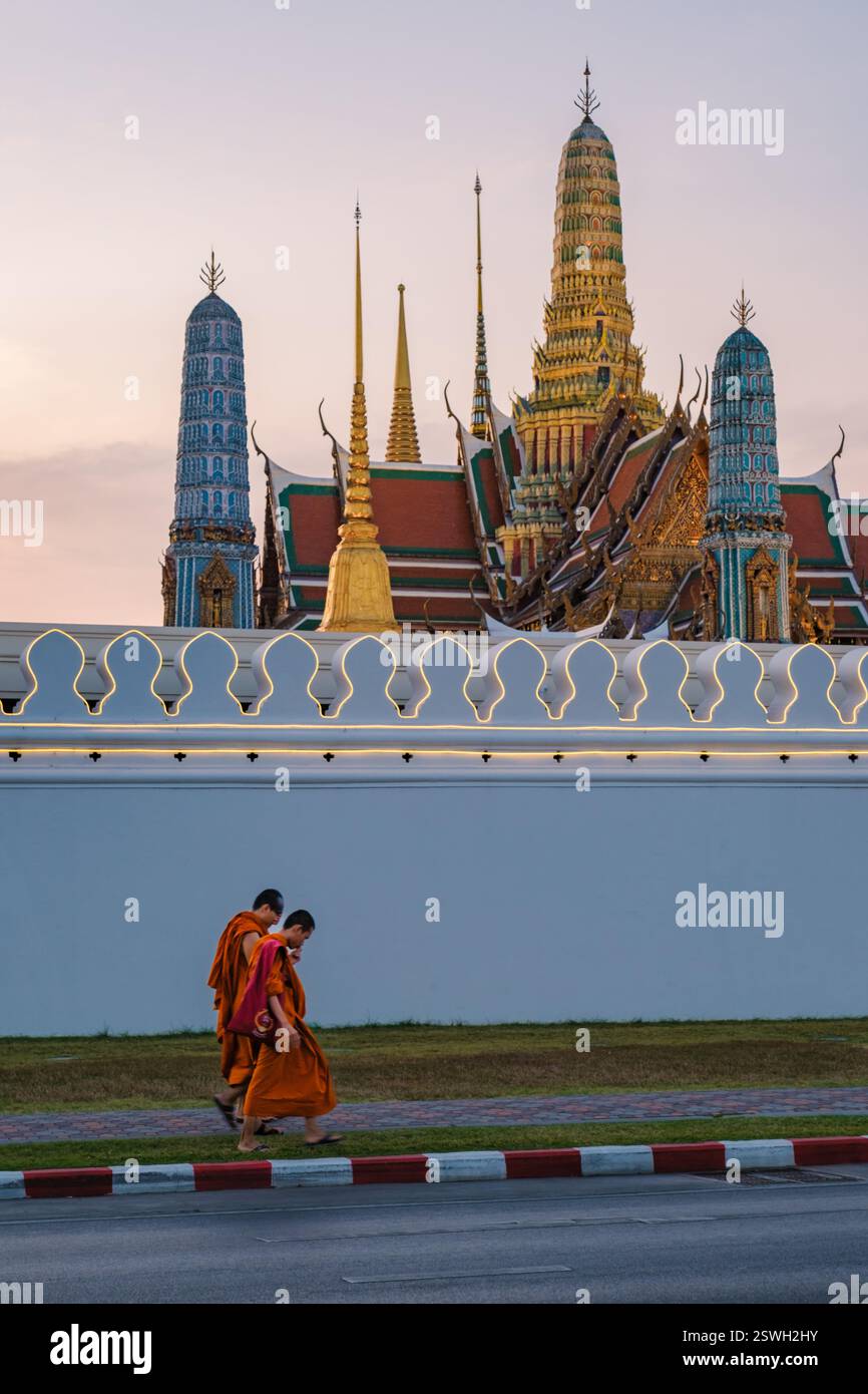 Vibrant evening stroll by monks near the stunning Grand Palace in ...