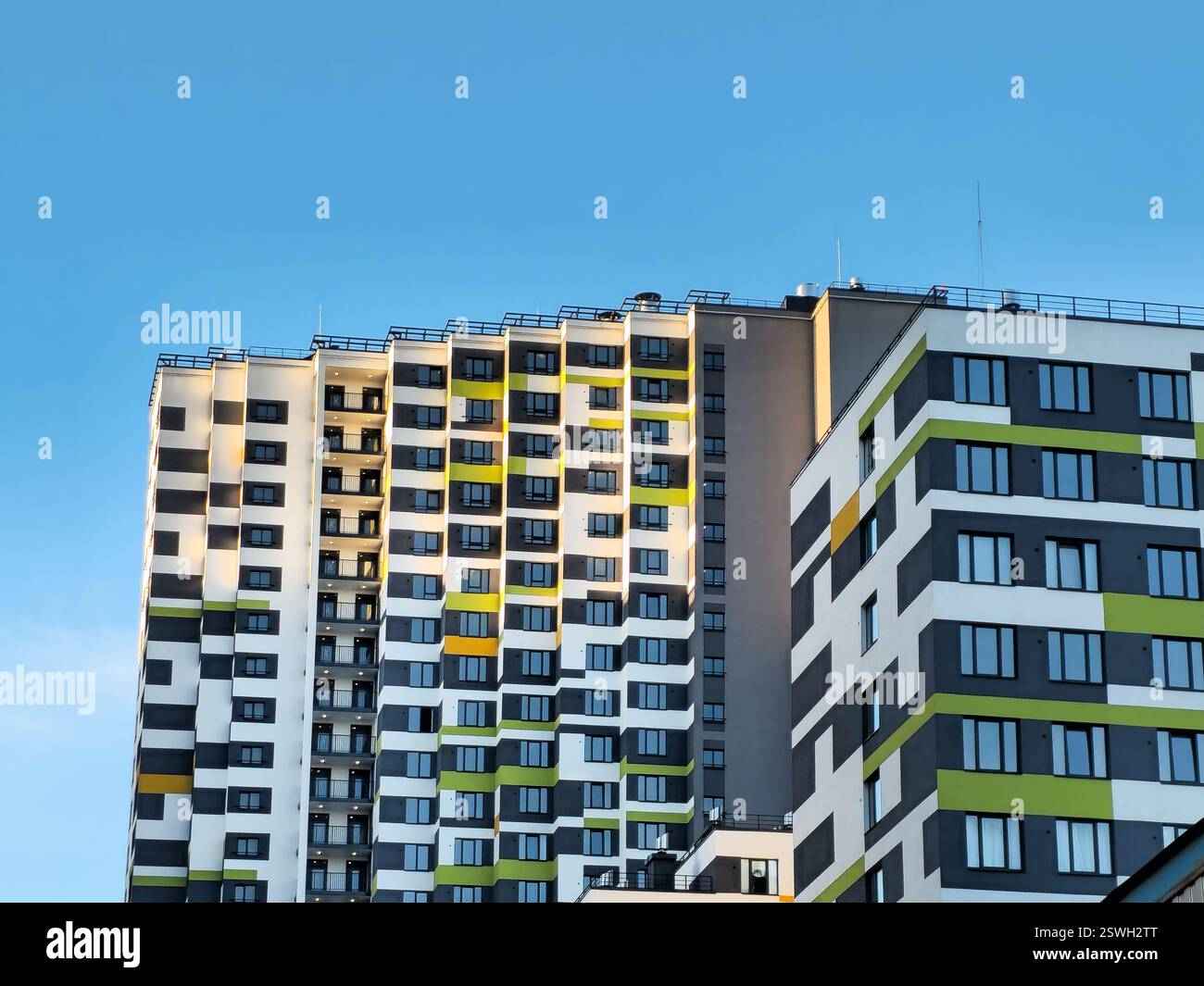Sunny evening light on the facade of a multi-storey building. Facade ...