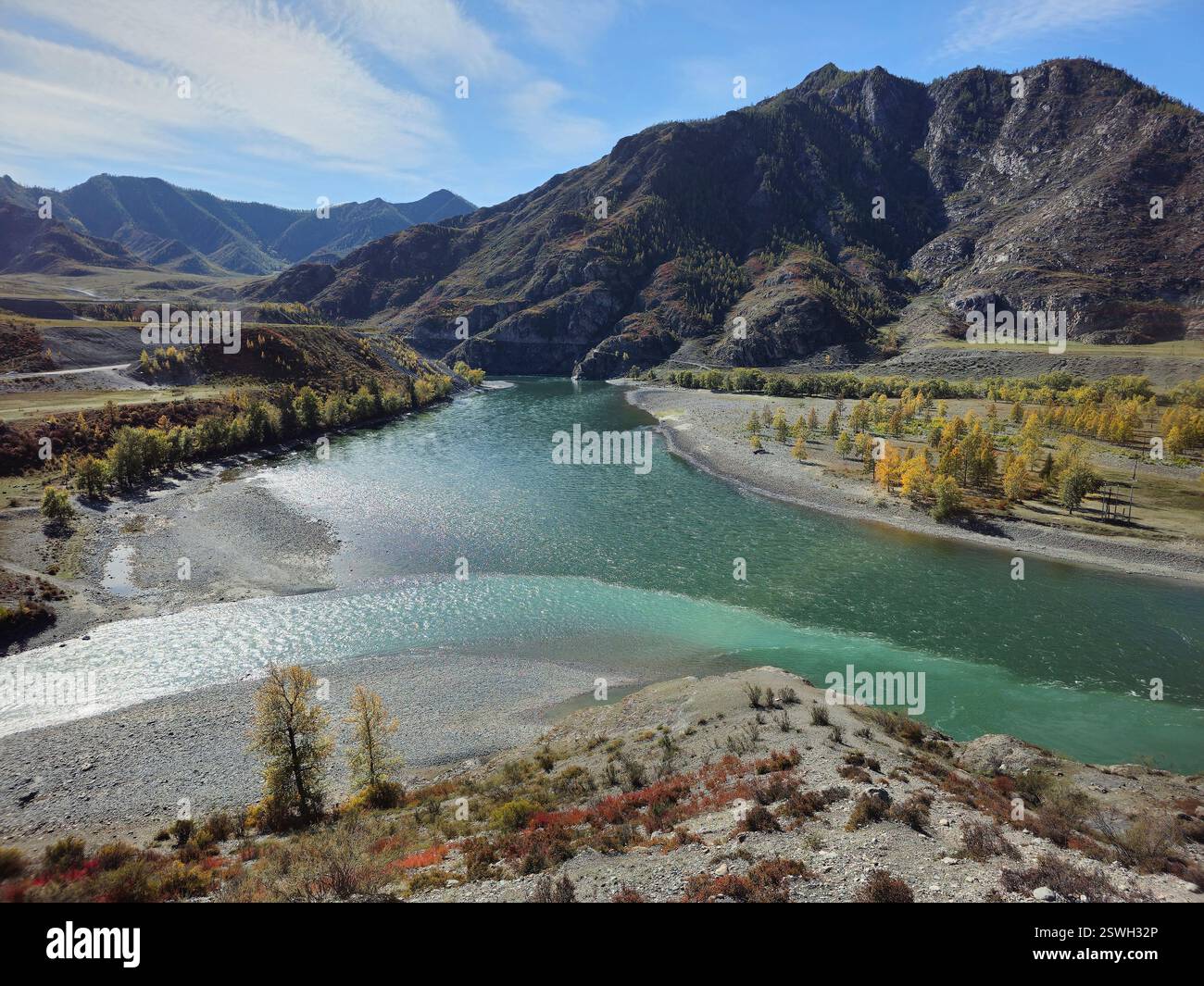 Autumn landscape with drought and turquoise river in the valley ...