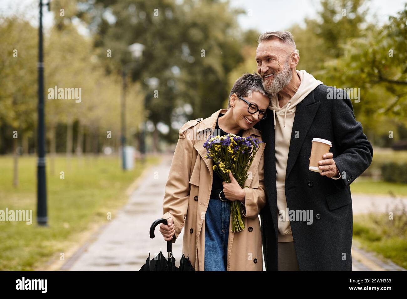 A mature couple enjoys a heartfelt moment while strolling through a ...