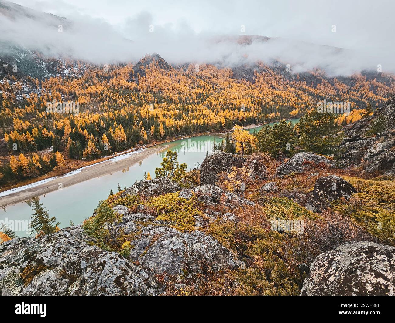 Granite cliff above the river. Stunning winding turquoise river in an ...