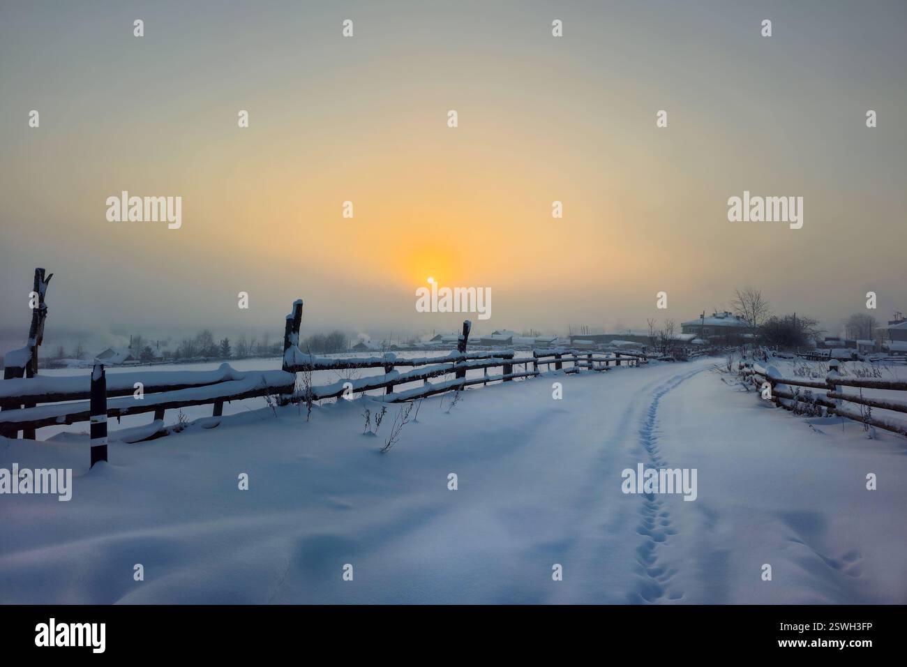 Beautiful winter morning. Frosty sunrise over the village. Misty ...