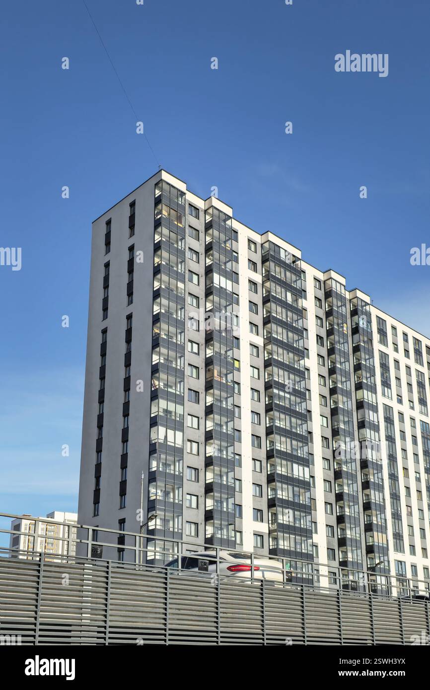 New grey high-rise building in a residential neighborhood Stock Photo ...