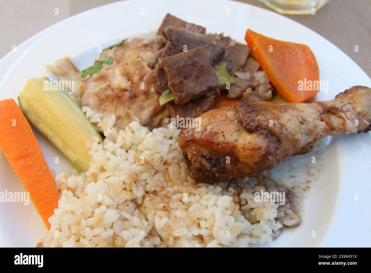 Egyptian rice with baked chicken drumstick, beef, carrot and cucumber ...