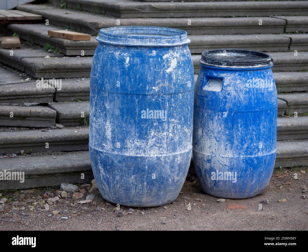 Plastic blue barrels on the construction site Stock Photo - Alamy