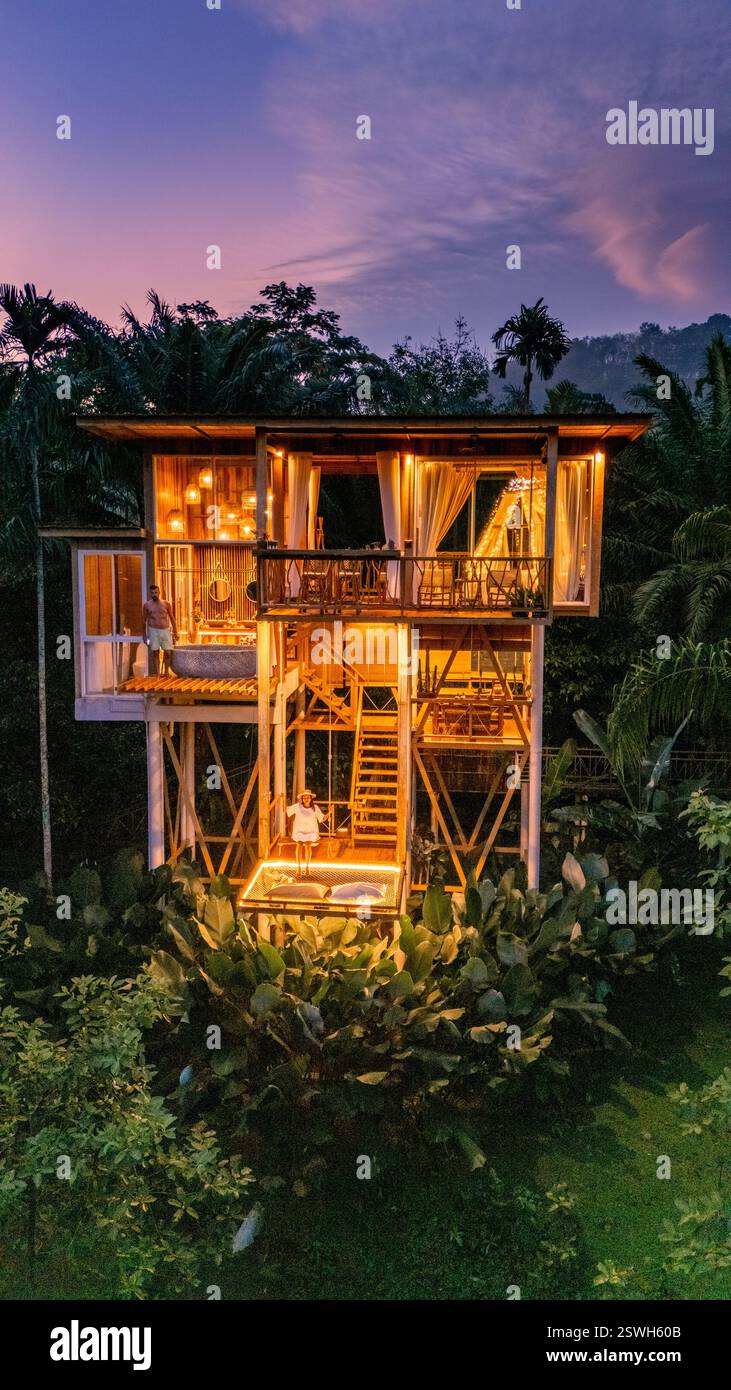 Dreamy treehouse retreat in Thailand or Bali during twilight hours ...