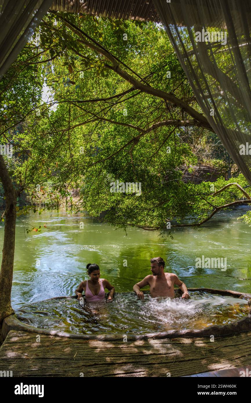 Relaxing in a tropical oasis with lush greenery and tranquil waters in ...