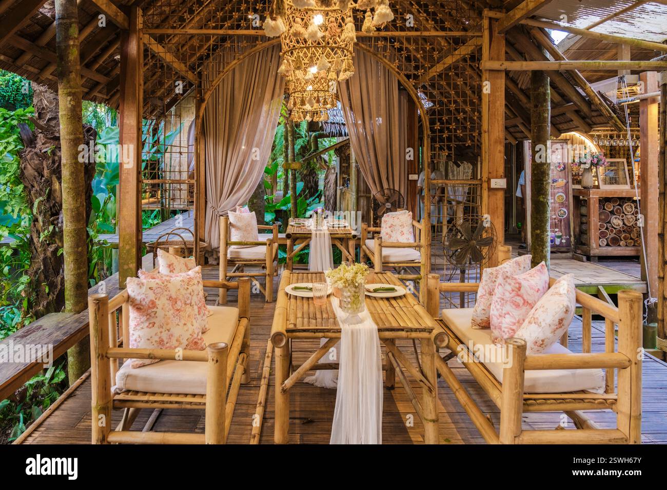 Cozy bamboo dining area in lush tropical setting blending Thailand and ...