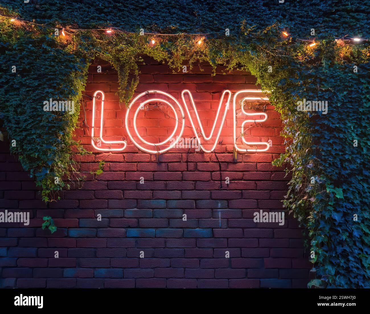 A vibrant neon love sign shines brightly amid lush green vines, perfect ...