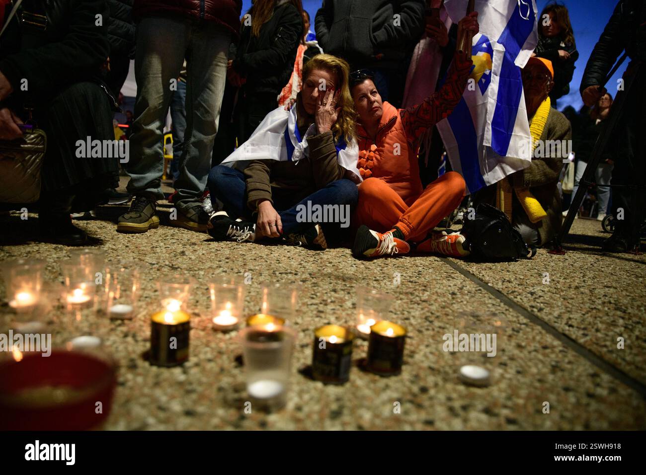Israel. 20th Feb, 2025. Israeli woman tear as she sits in front of ...