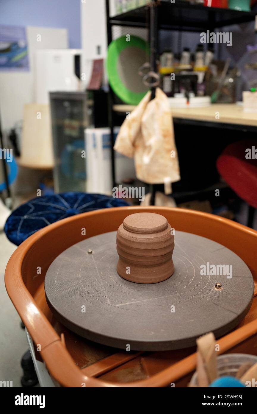 Clay pottery on a spinning wheel in a ceramics studio workspace Stock ...