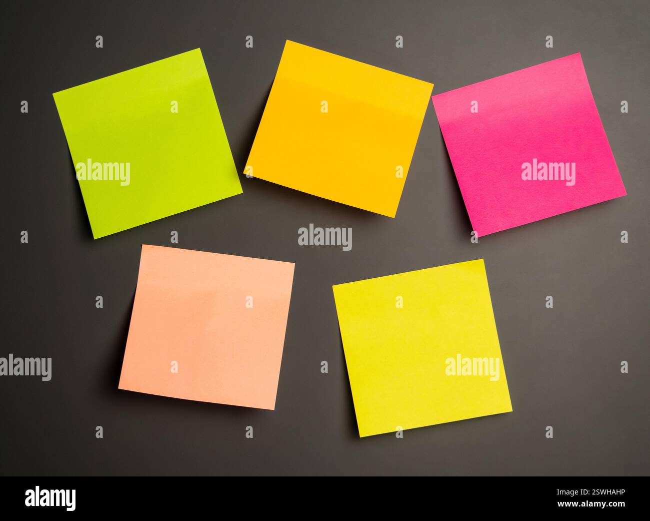 Brightly colored sticky notes are placed on a dark background ...
