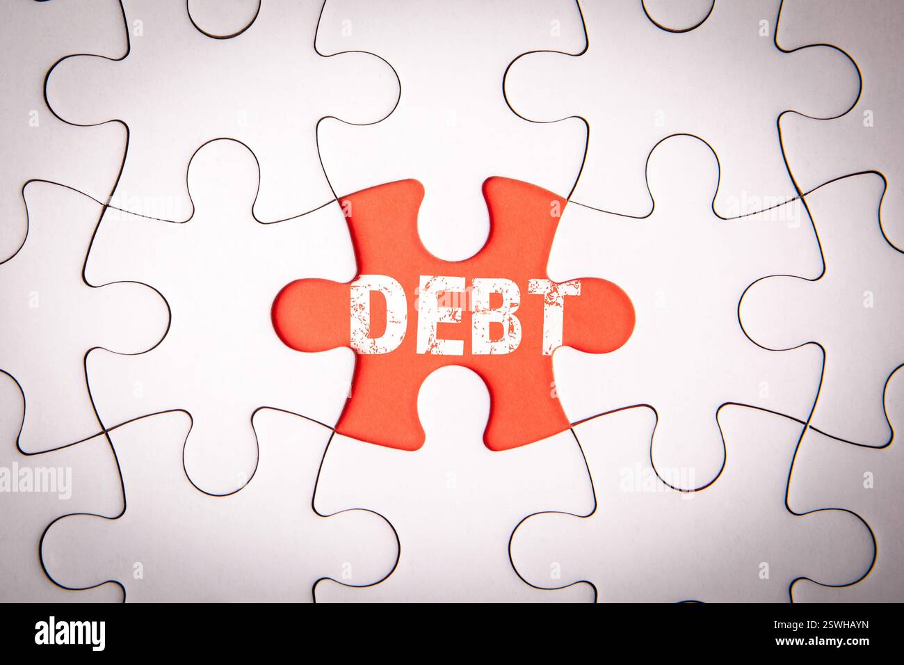 Debt. White puzzle pieces on an red background Stock Photo - Alamy