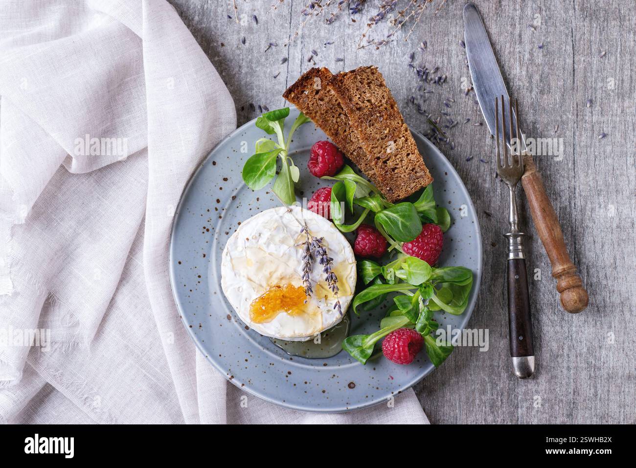 Goat cheese with honey and raspberries Stock Photo - Alamy