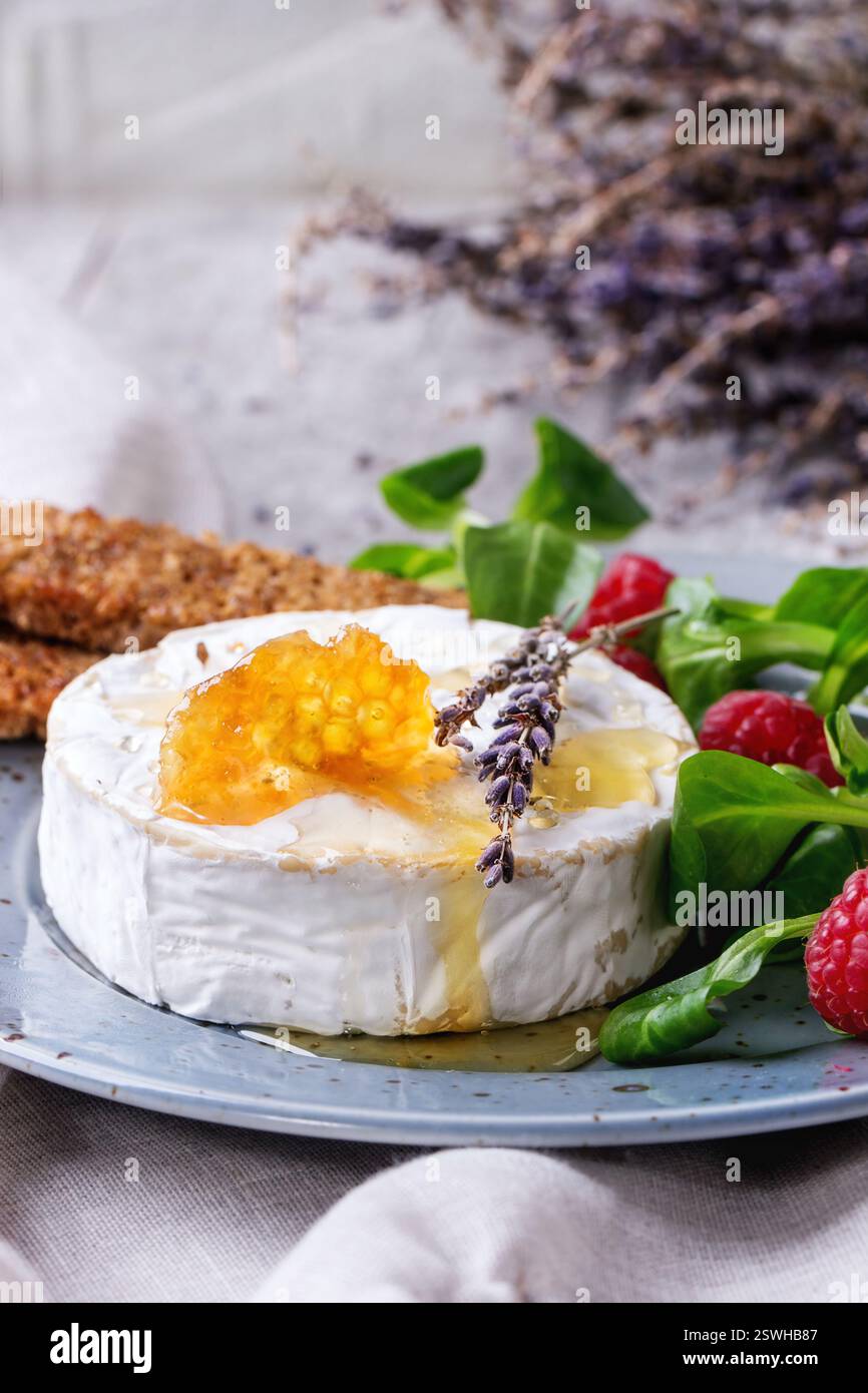 Goat cheese with honey and raspberries Stock Photo - Alamy