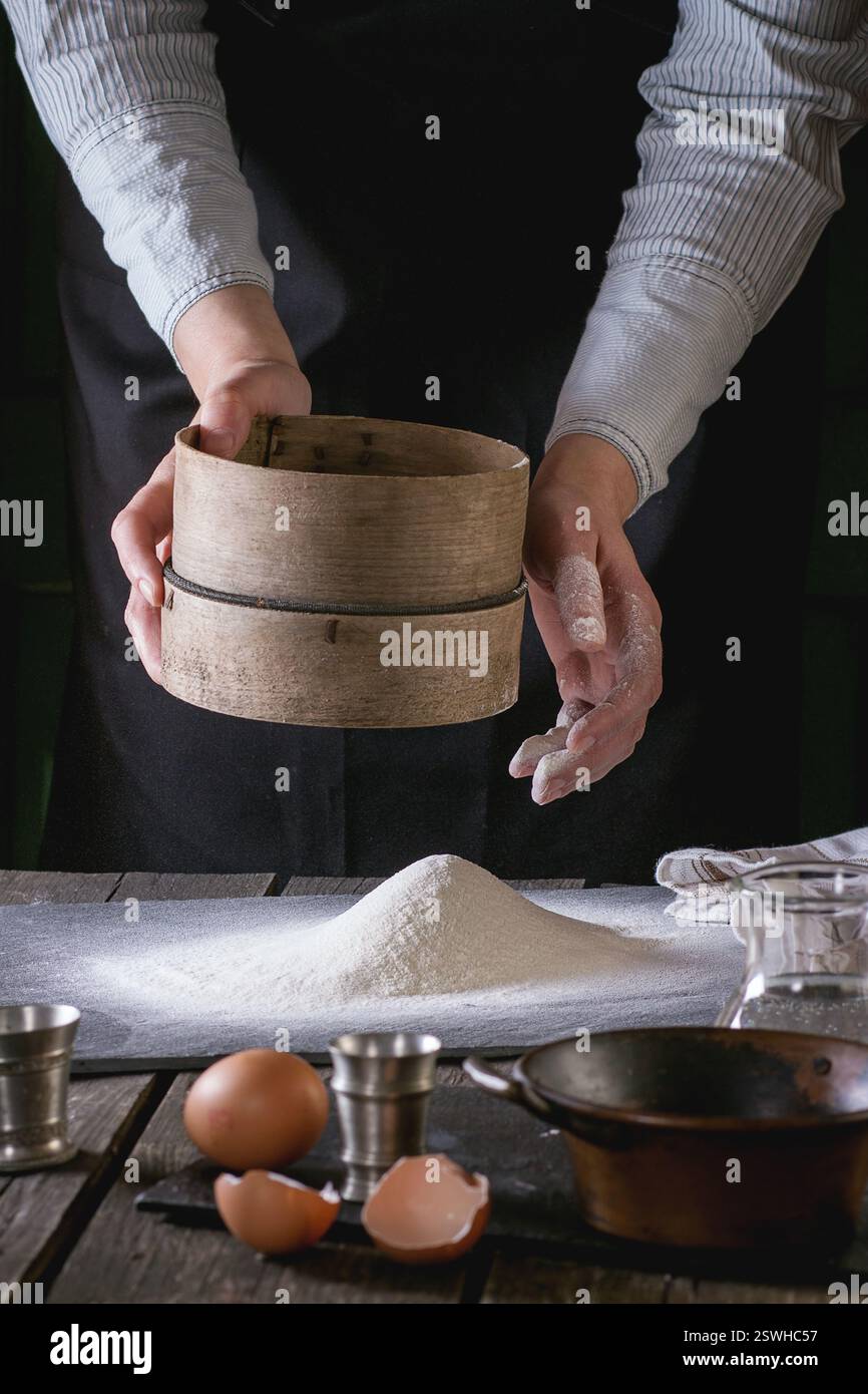 Sifting flour by female hands Stock Photo - Alamy