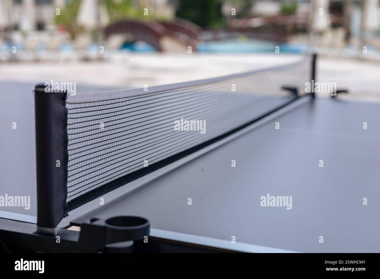 A ping pong table with a net is set up in a courtyard, providing guests ...